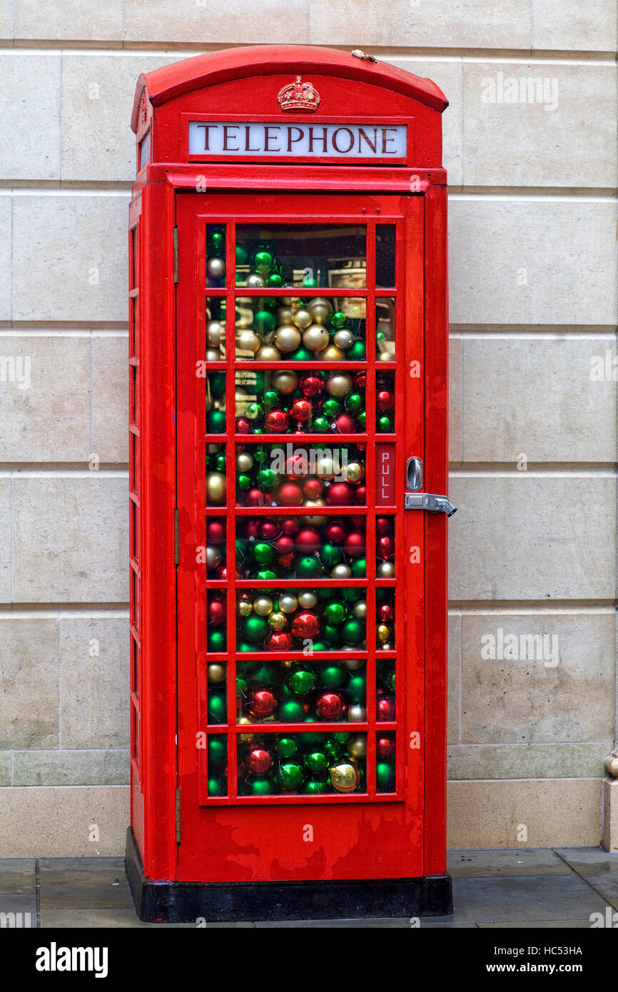 Red Public Telephone Box filled with Christmas Baubles Stock Photo - Alamy
