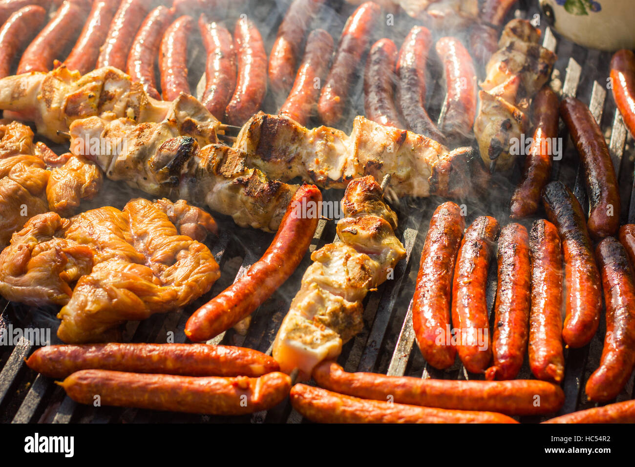 Grilled meat on the barbecue,cooked outdoor Stock Photo - Alamy