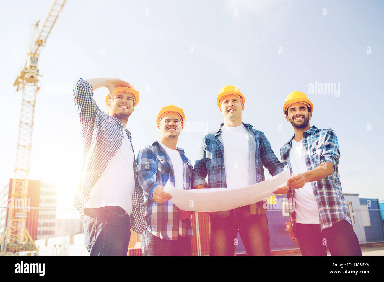 group of builders with tablet pc and blueprint Stock Photo - Alamy