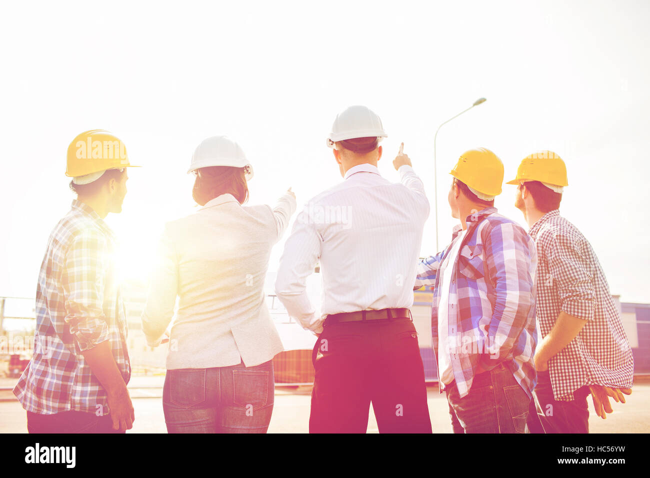 group of builders and architects at building site Stock Photo - Alamy