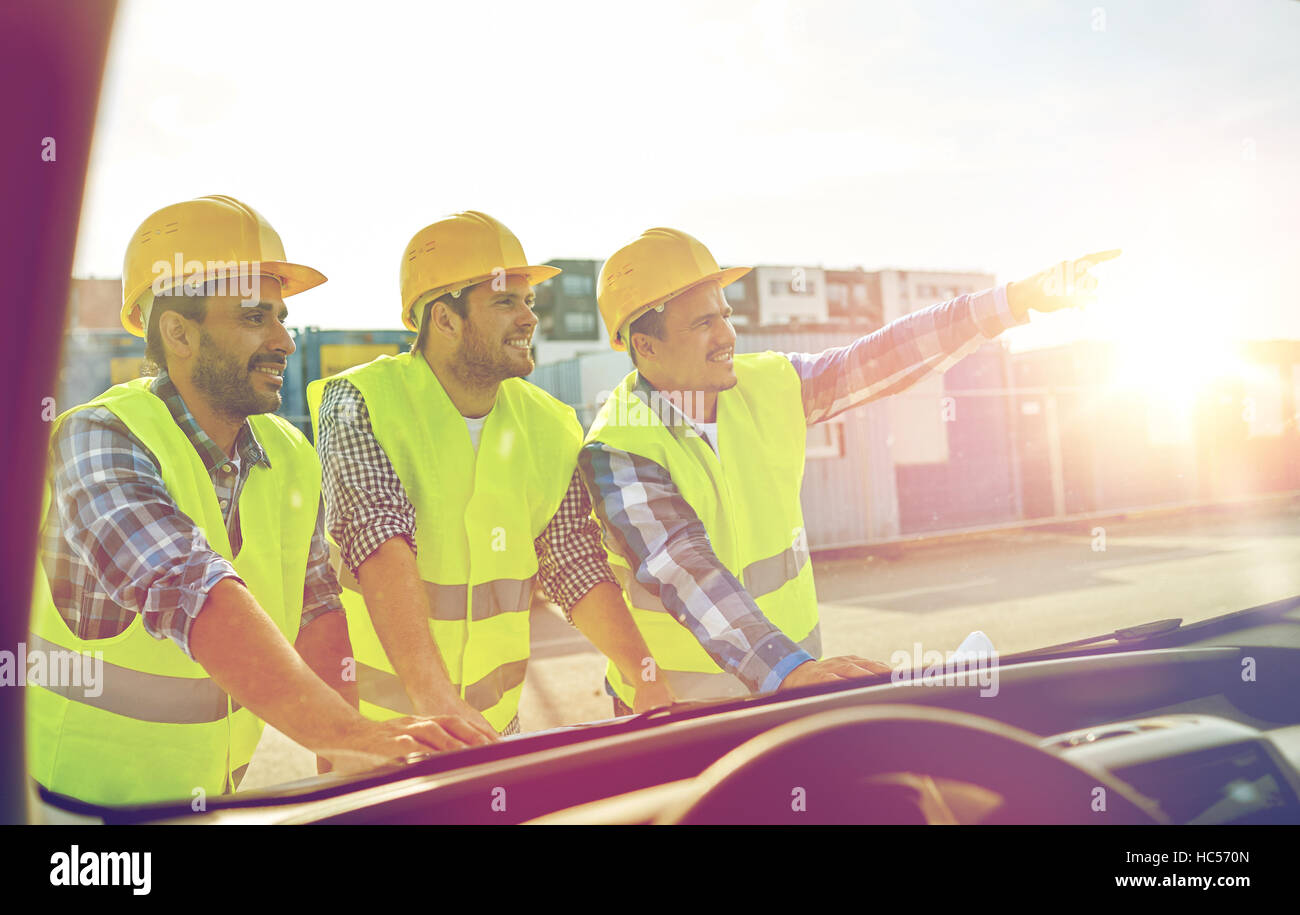 close up of builders with blueprint on car hood Stock Photo - Alamy