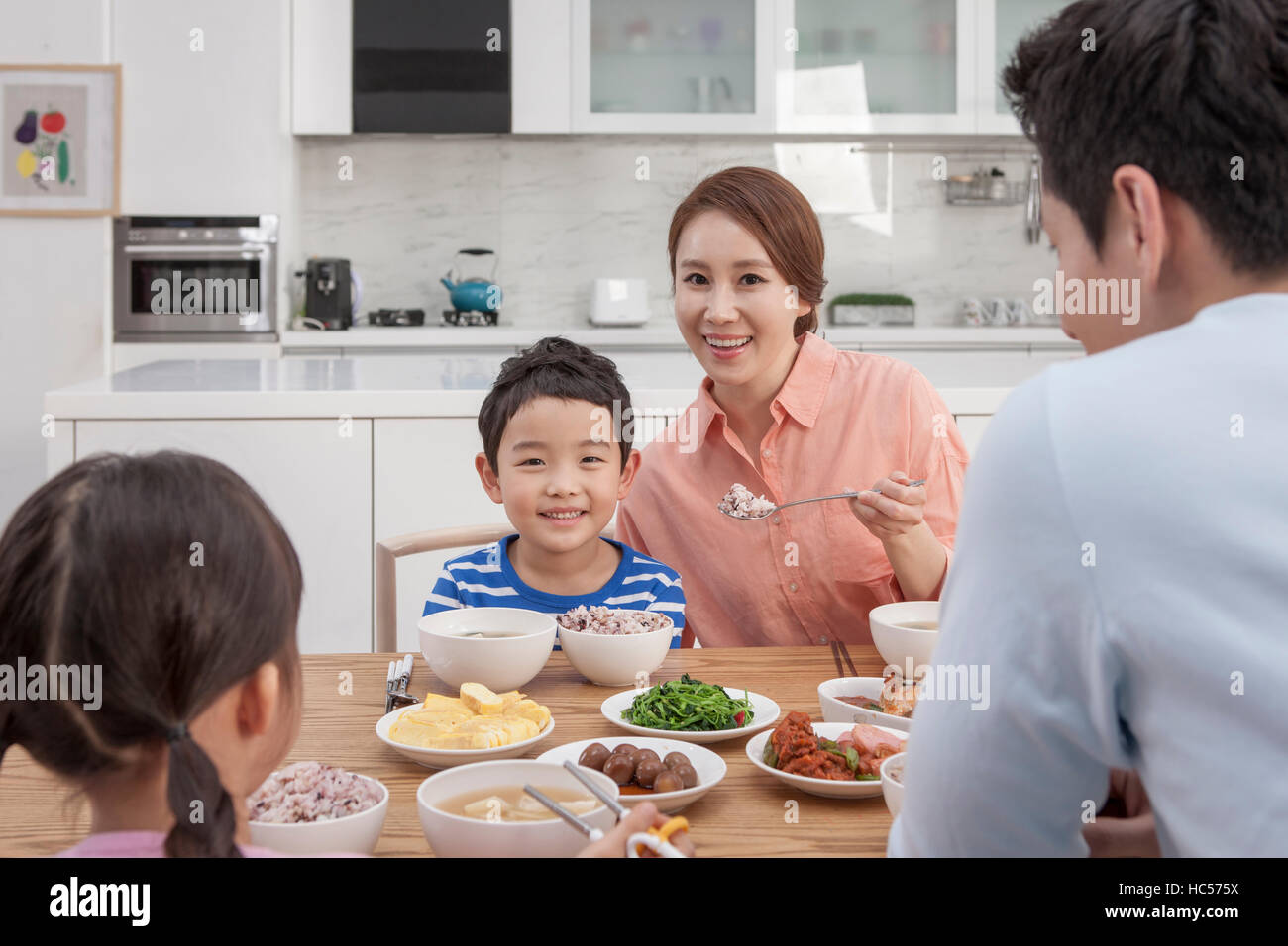 Harmonious family having meals Stock Photo - Alamy