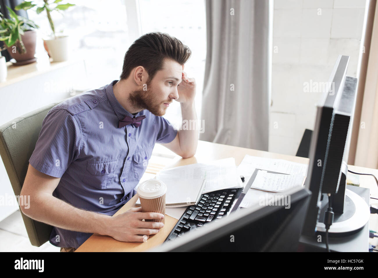 creative male worker with computer drinking coffee Stock Photo - Alamy