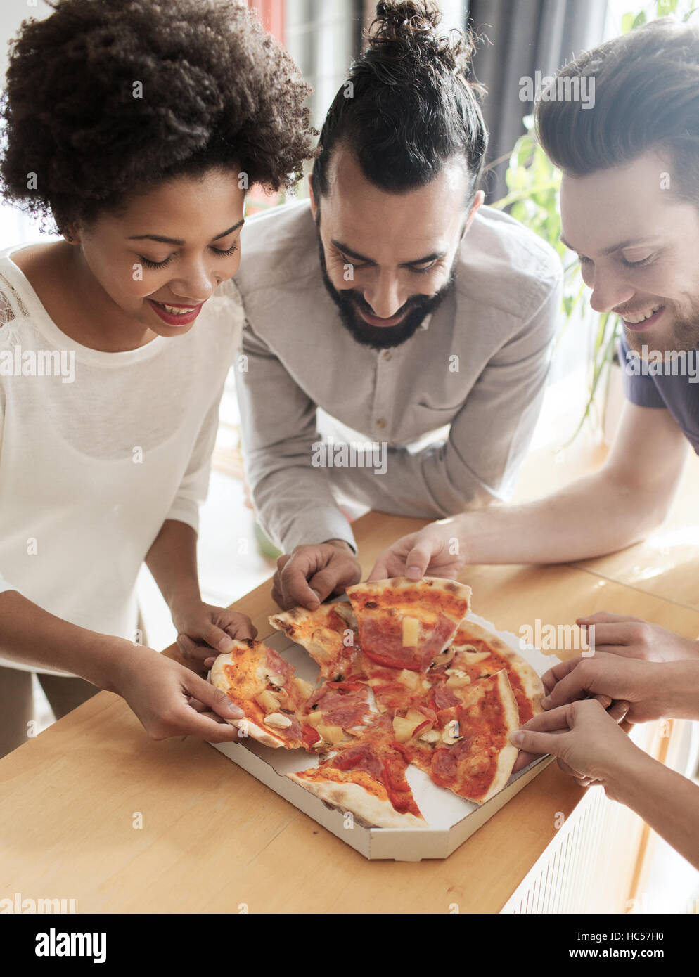 happy business team eating pizza in office Stock Photo - Alamy