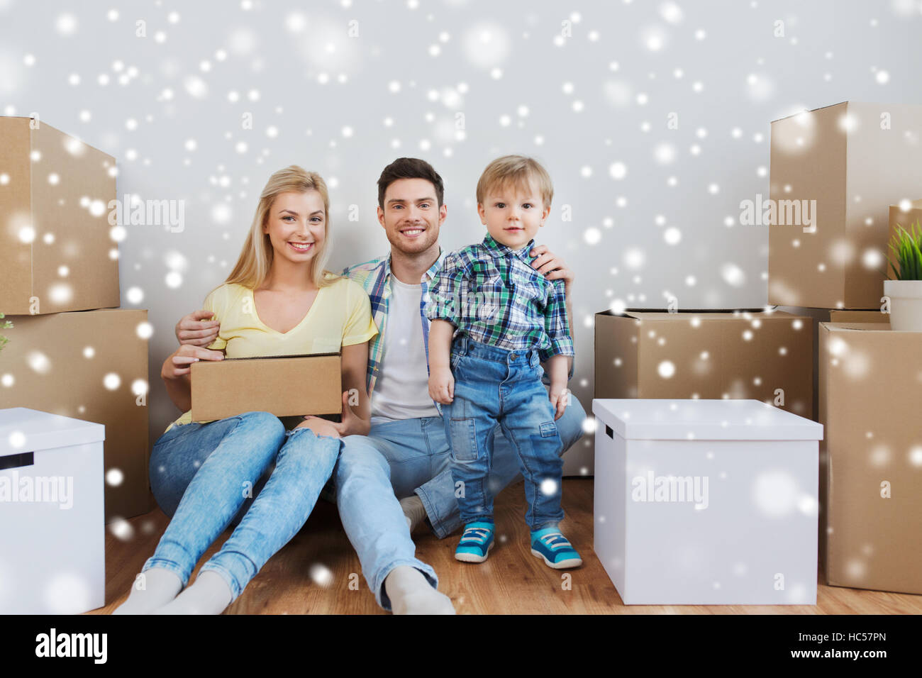 happy family with boxes moving to new home Stock Photo - Alamy