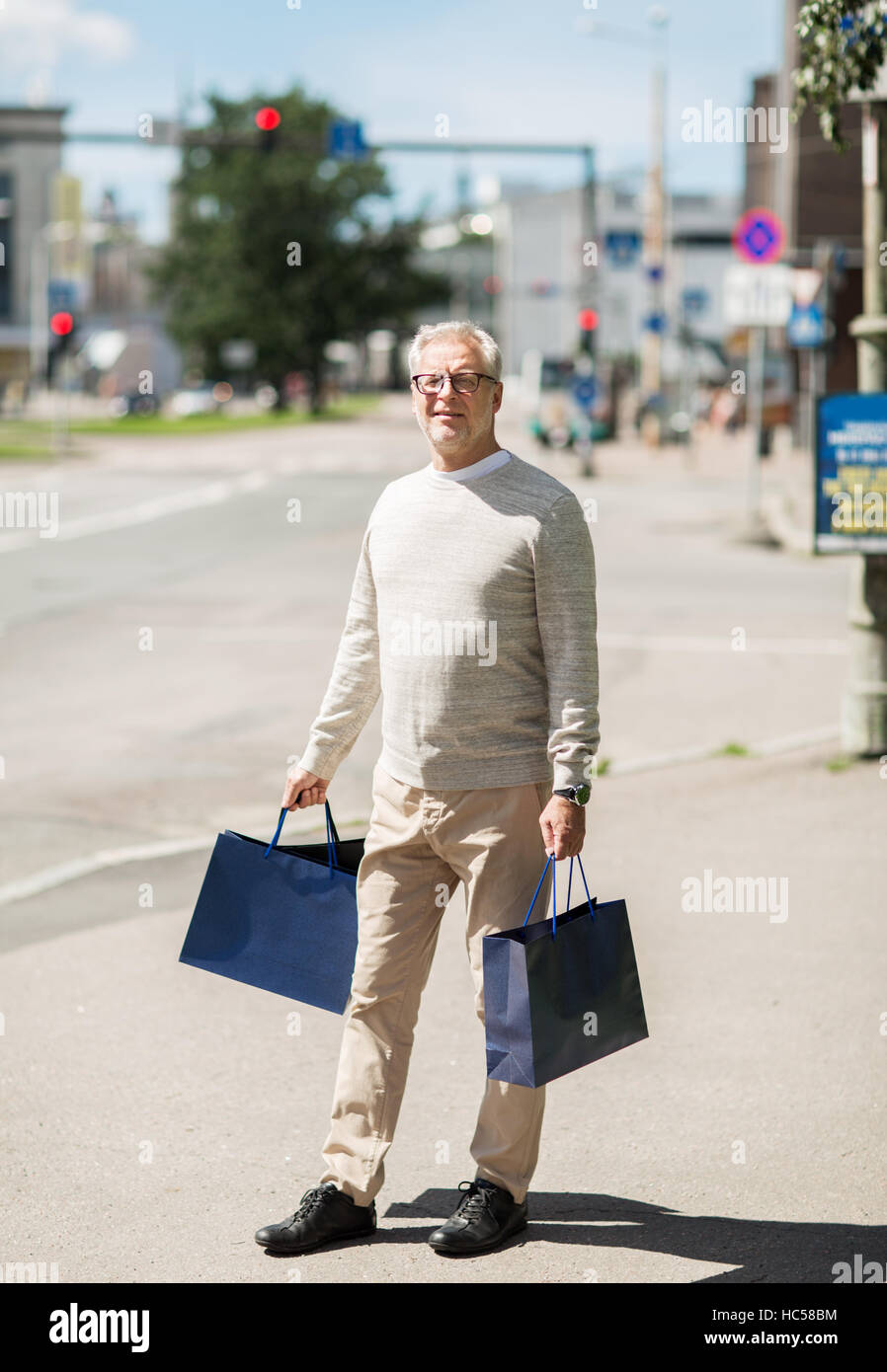 Old man carrying bags hi-res stock photography and images - Alamy