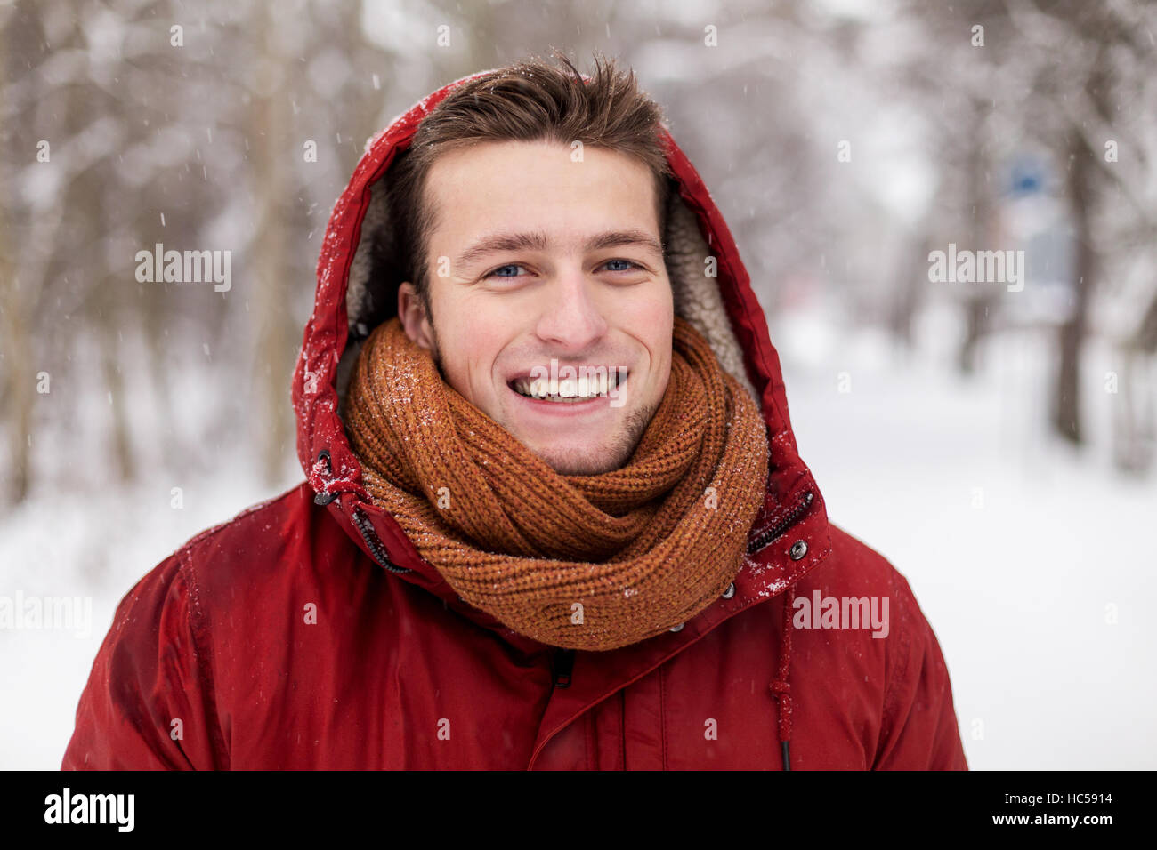 happy man in winter jacket with hood outdoors Stock Photo - Alamy