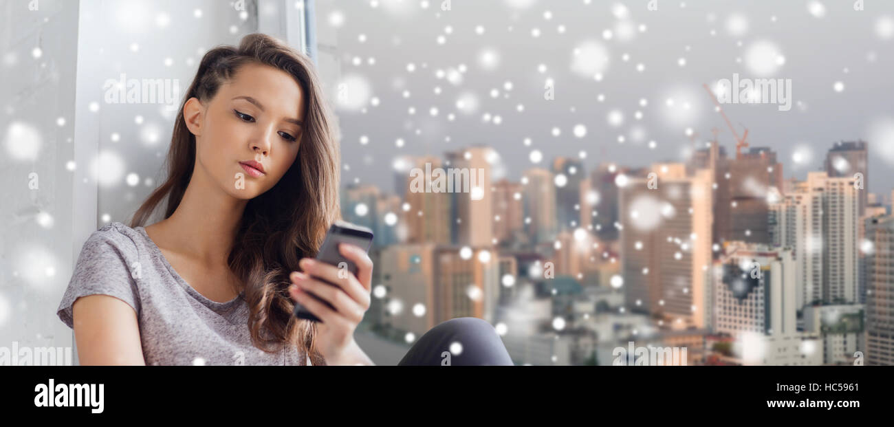sad pretty teenage girl with smartphone texting Stock Photo - Alamy
