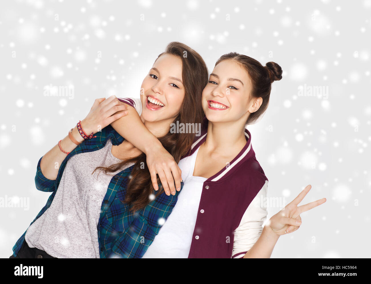 happy teenage girls hugging and showing peace sign Stock Photo - Alamy