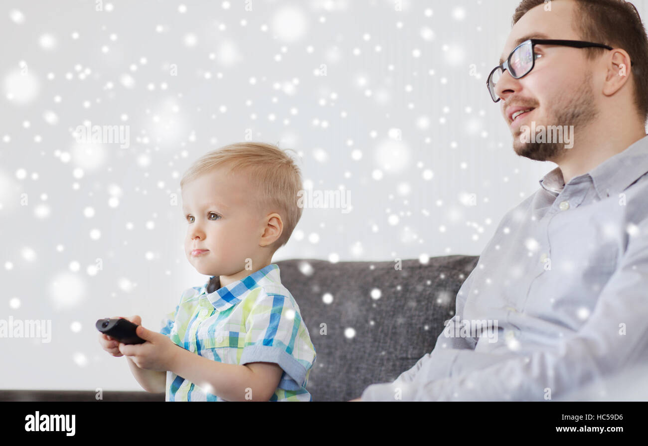 father and son with remote watching tv at home Stock Photo - Alamy