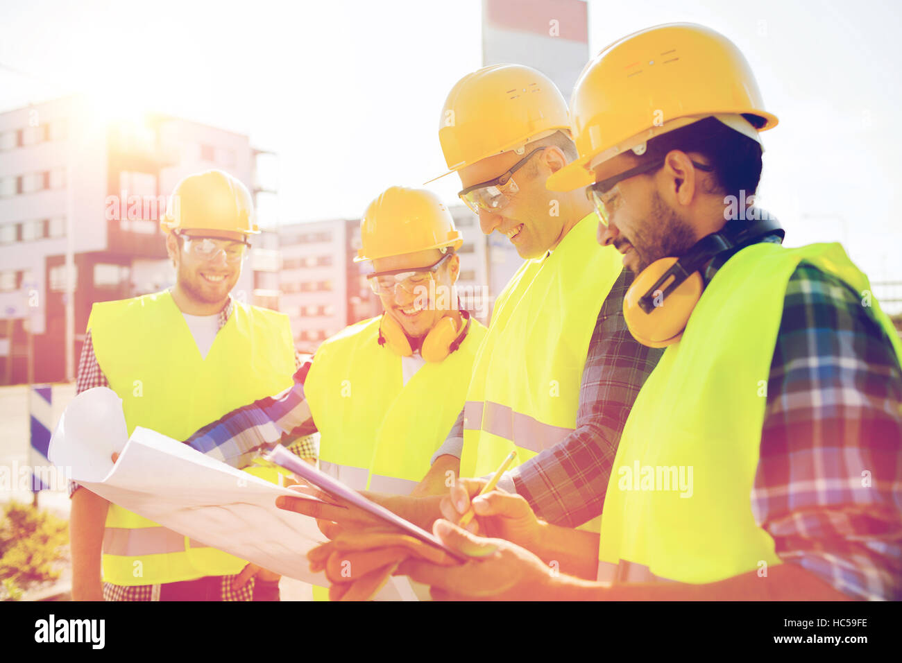 group of builders with tablet pc and blueprint Stock Photo - Alamy