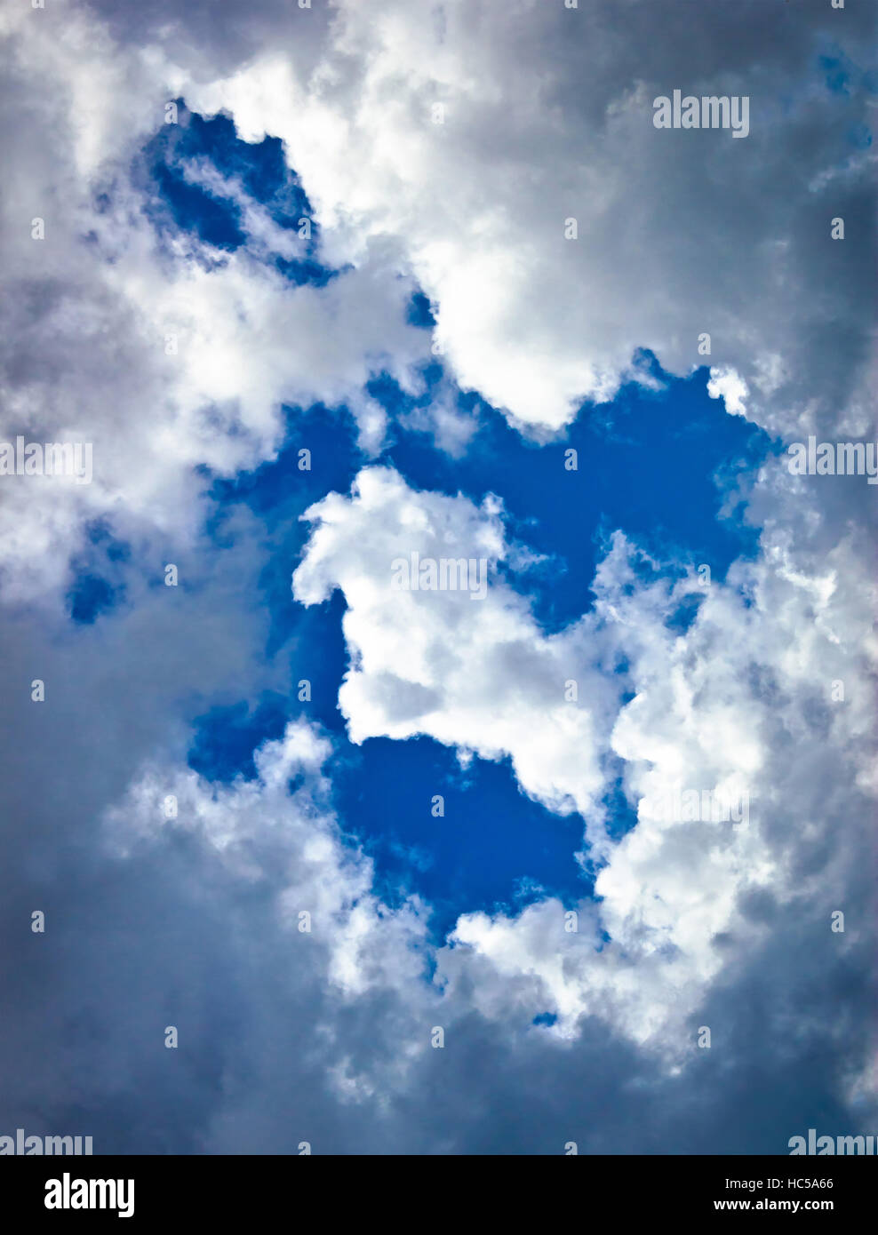 White and dark clouds on blue sky, vertical view Stock Photo - Alamy