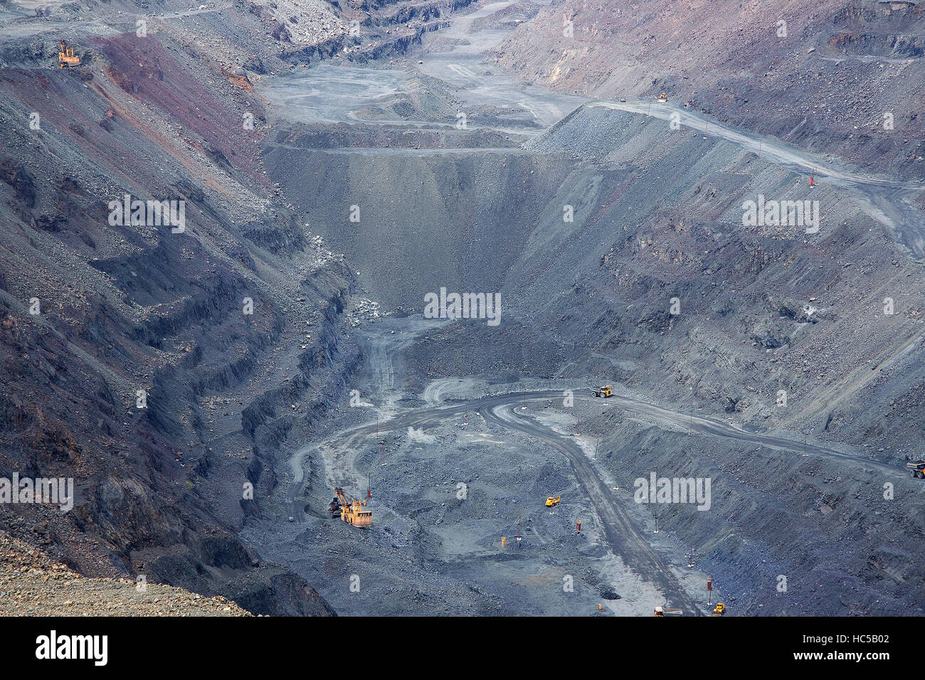 Iron ore opencast mining quarry with lots of machinery at work - view ...