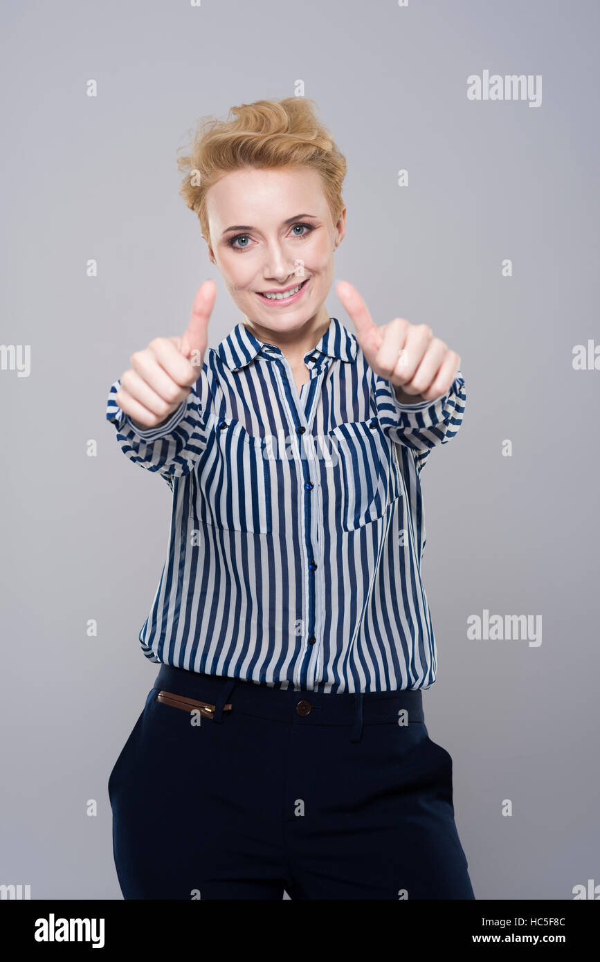 Woman posing with her thumbs up Stock Photo - Alamy