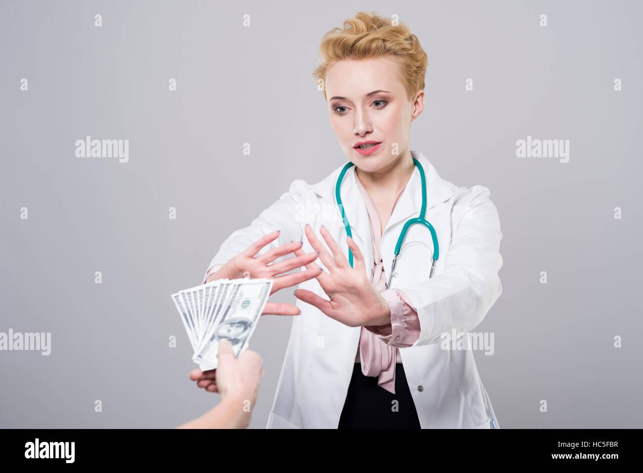 Doctor does not accept the bribe Stock Photo - Alamy