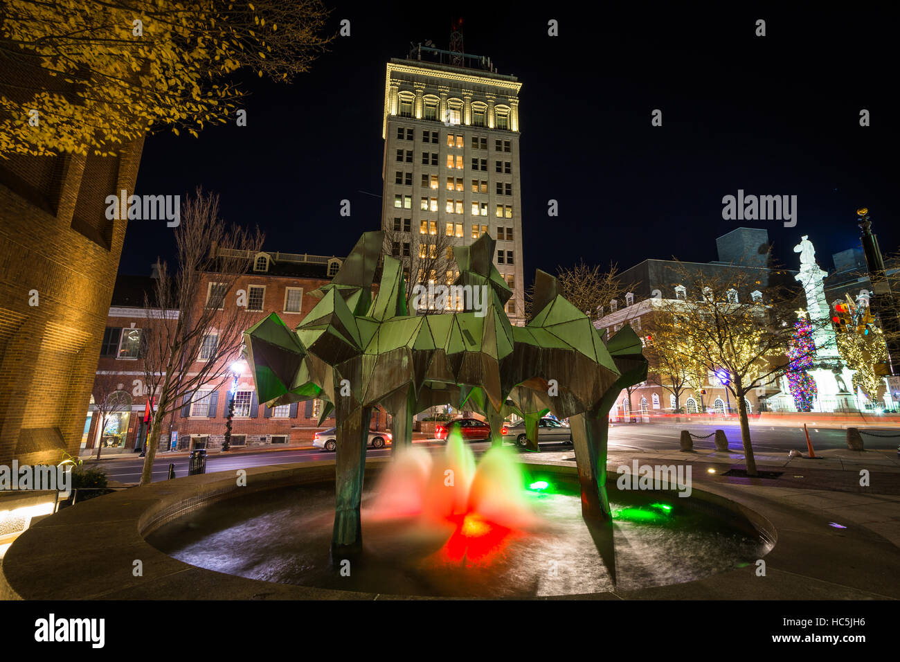 Fountain and highrise building at night, at Penn Square, in downtown ...