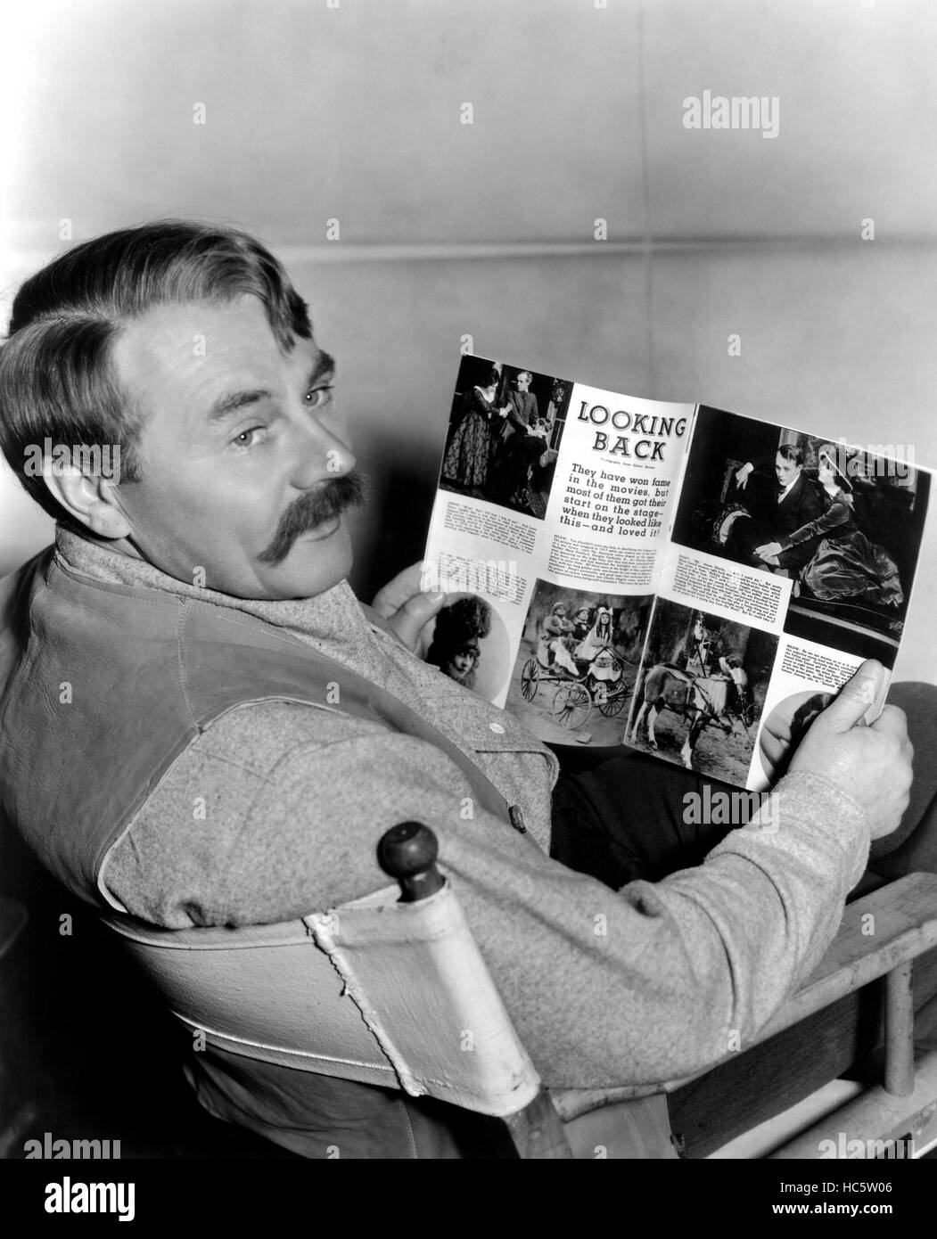 RUGGLES OF RED GAP, Charles Ruggles reading fan magazine, on set, 1935 ...