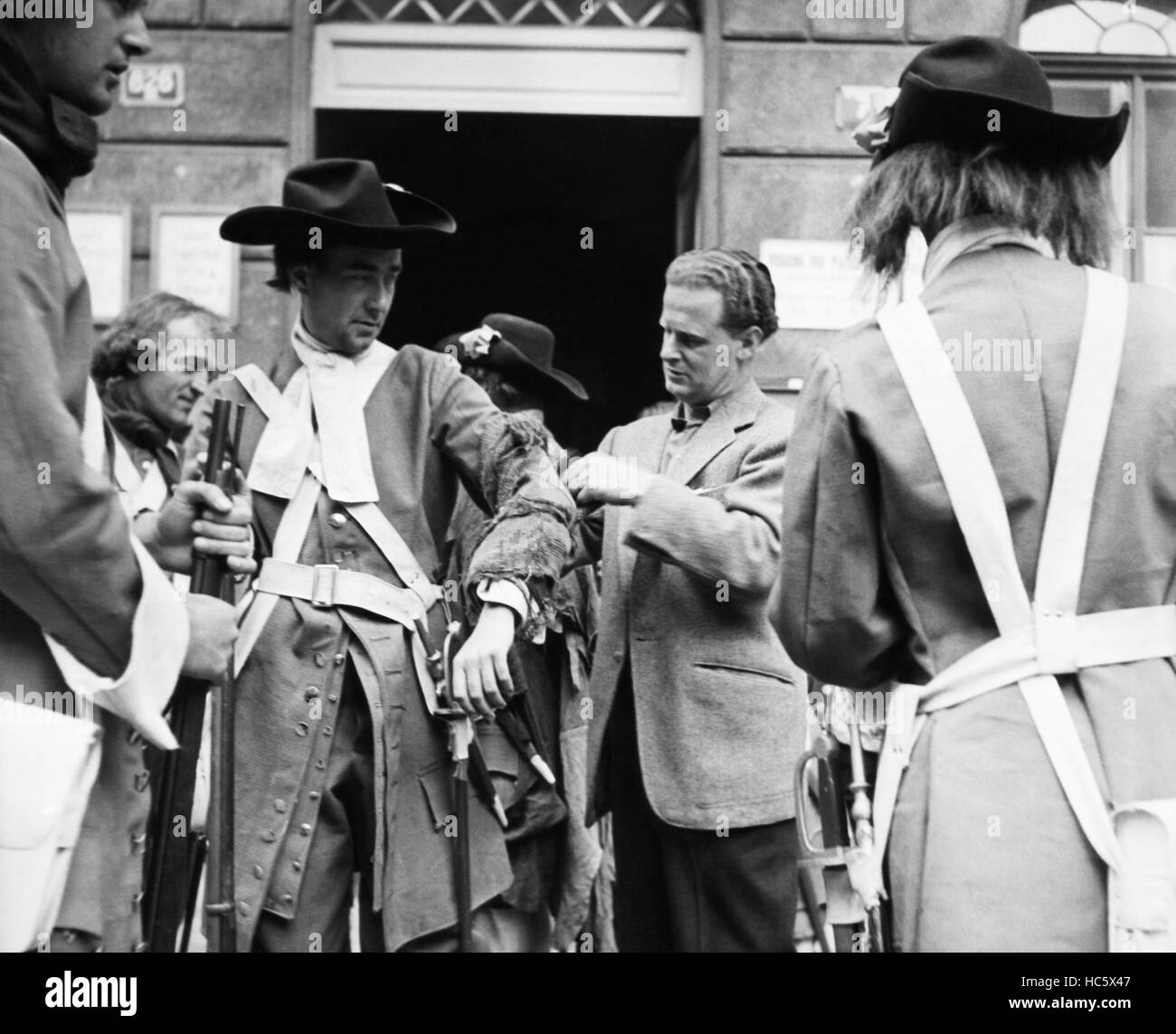 SARABAND FOR DEAD LOVERS, director Basil Dearden (right) adjusts the ...