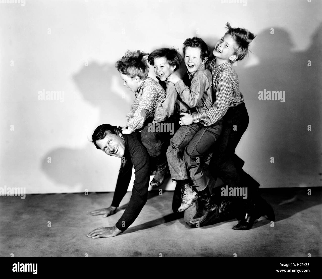 SADDLE TRAMP, Joel McCrea, giving a ride to (from left) Gregory Moffett ...