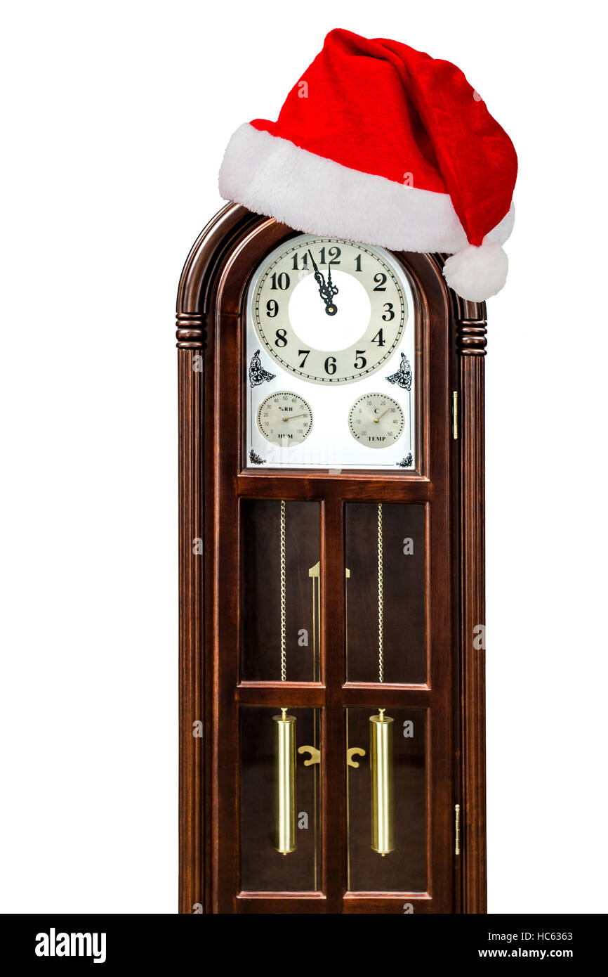 Grandfather clock and cap of Santa Claus, isolated on white background ...