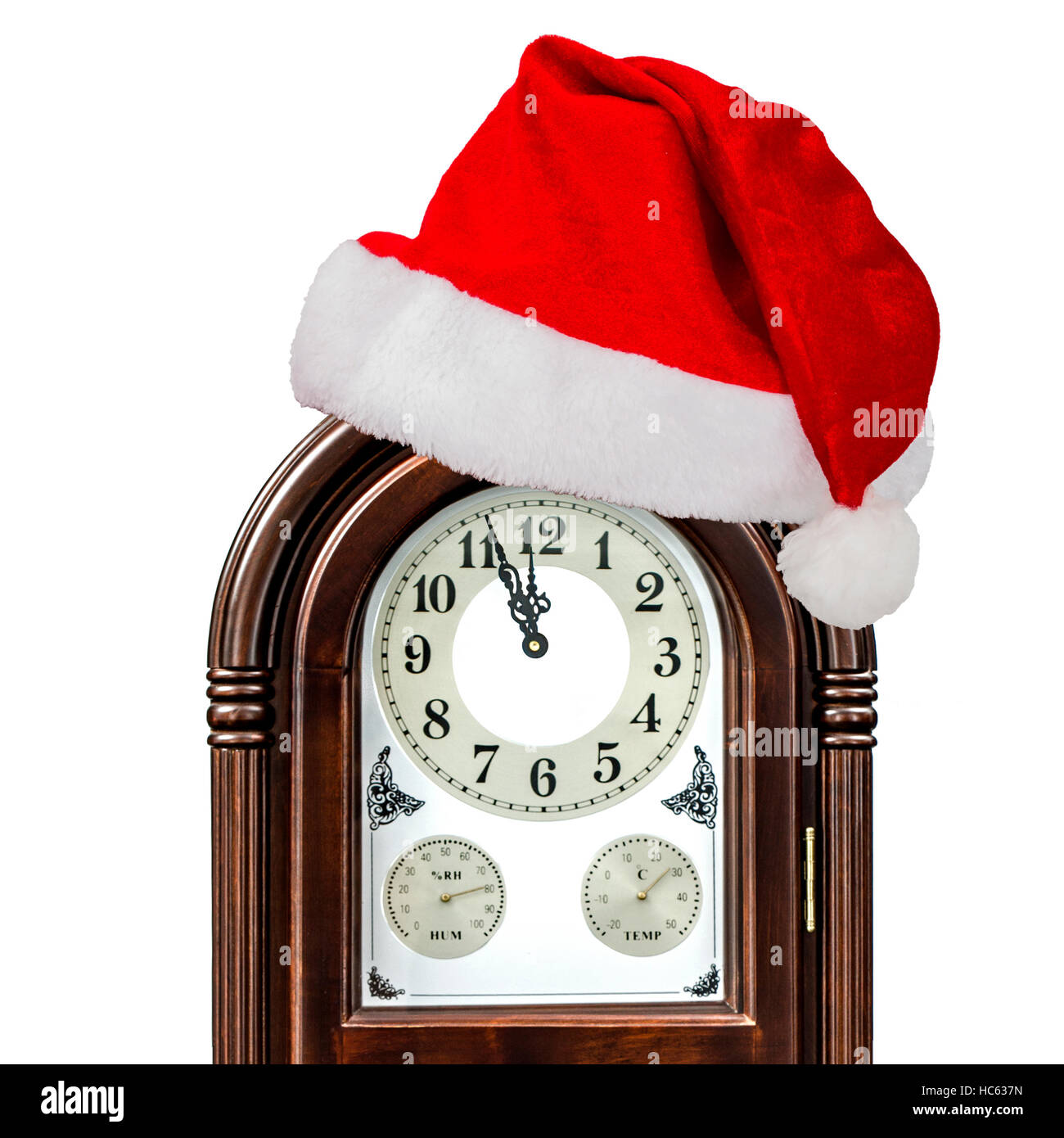 Grandfather clock and cap of Santa Claus, isolated on white background ...