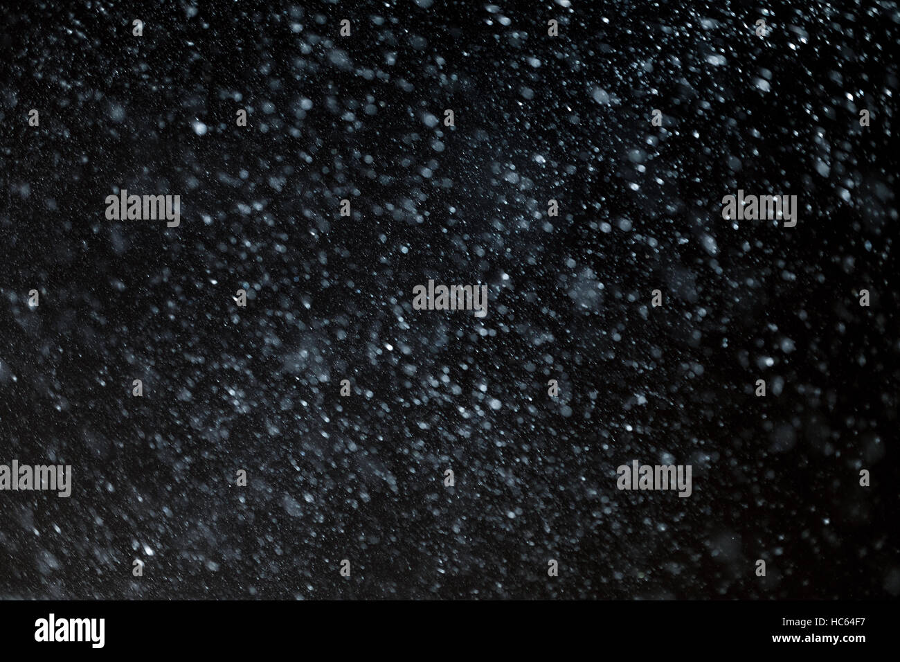 Real snow on black background Stock Photo - Alamy