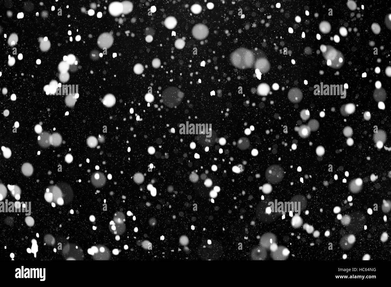 Real snow on black background Stock Photo - Alamy