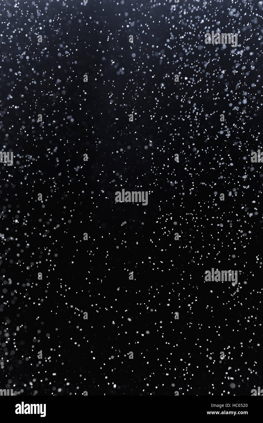 Real snow on black background Stock Photo - Alamy