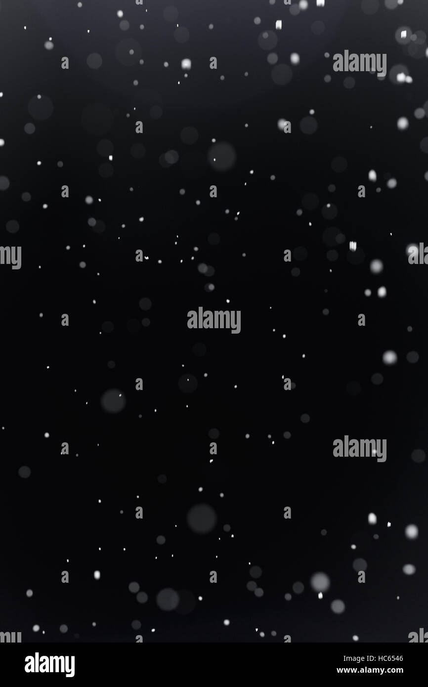Real snow on black background Stock Photo - Alamy