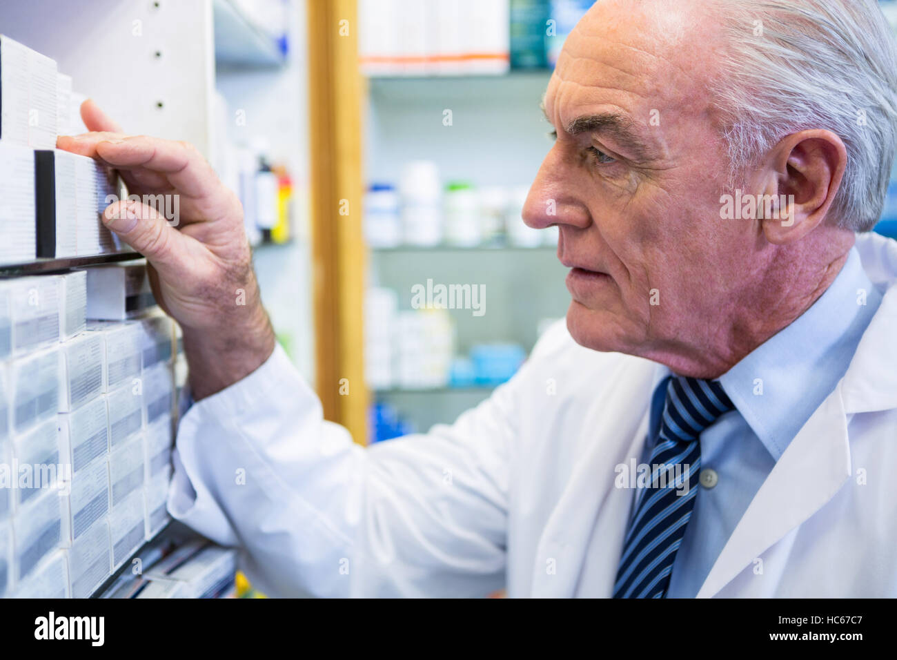 Pharmacist checking medicines Stock Photo - Alamy