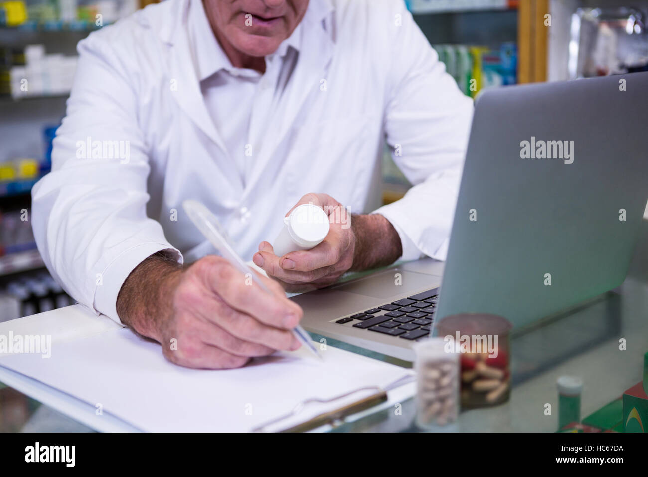 Pharmacist writing prescriptions for medicines Stock Photo - Alamy
