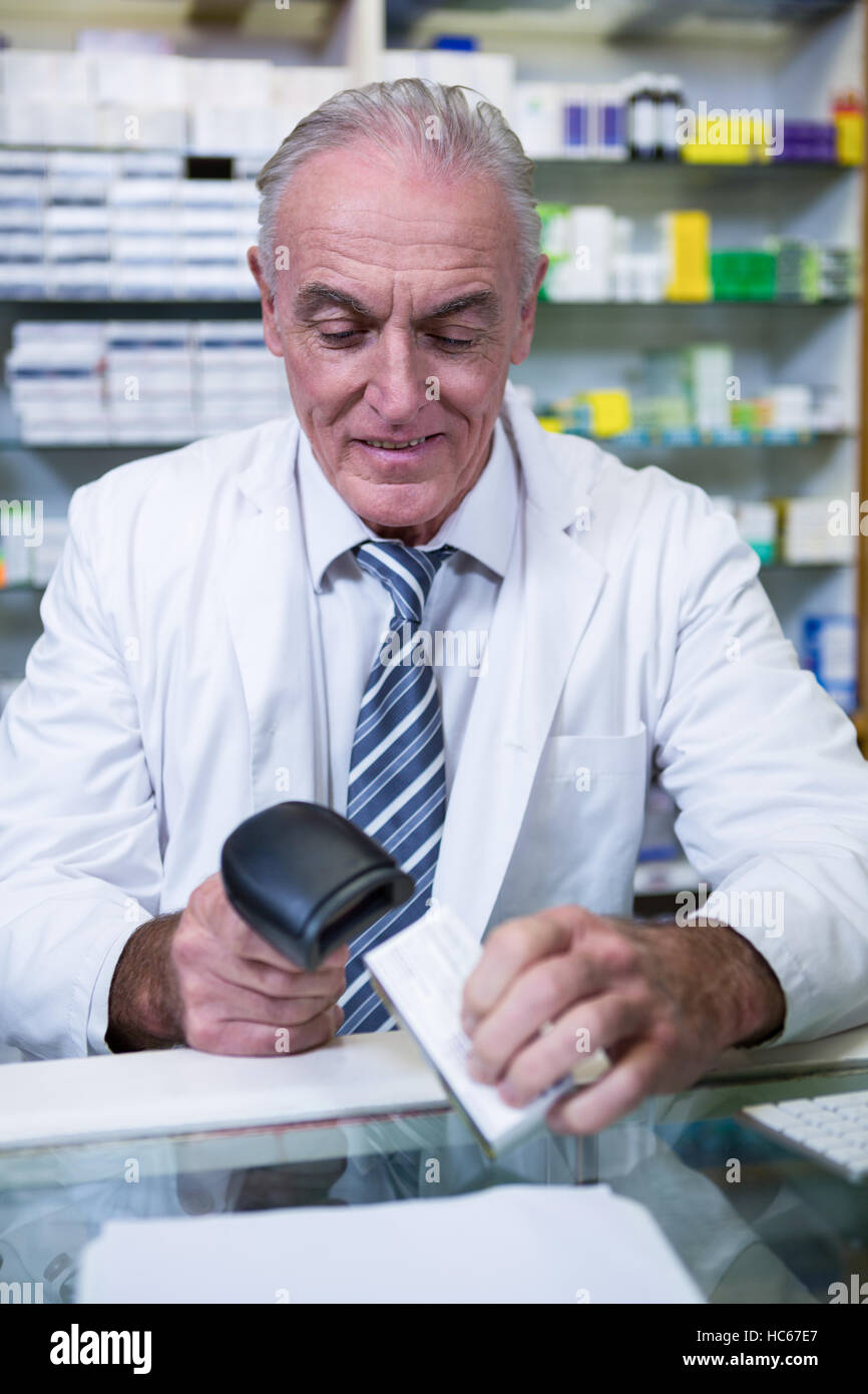 Pharmacist using barcode scanner on medicine box Stock Photo - Alamy