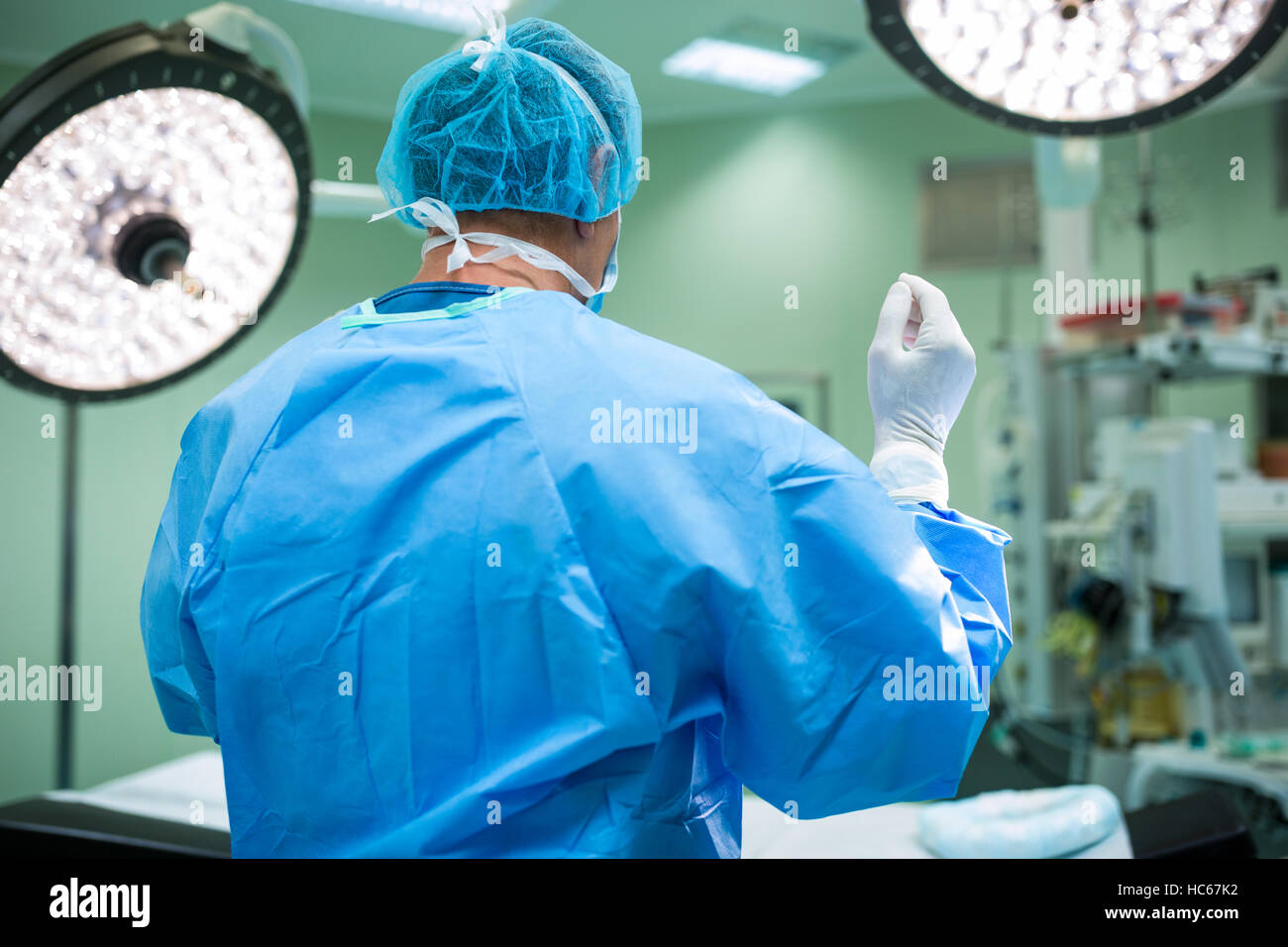 Rear view of surgeon standing in operation room Stock Photo - Alamy
