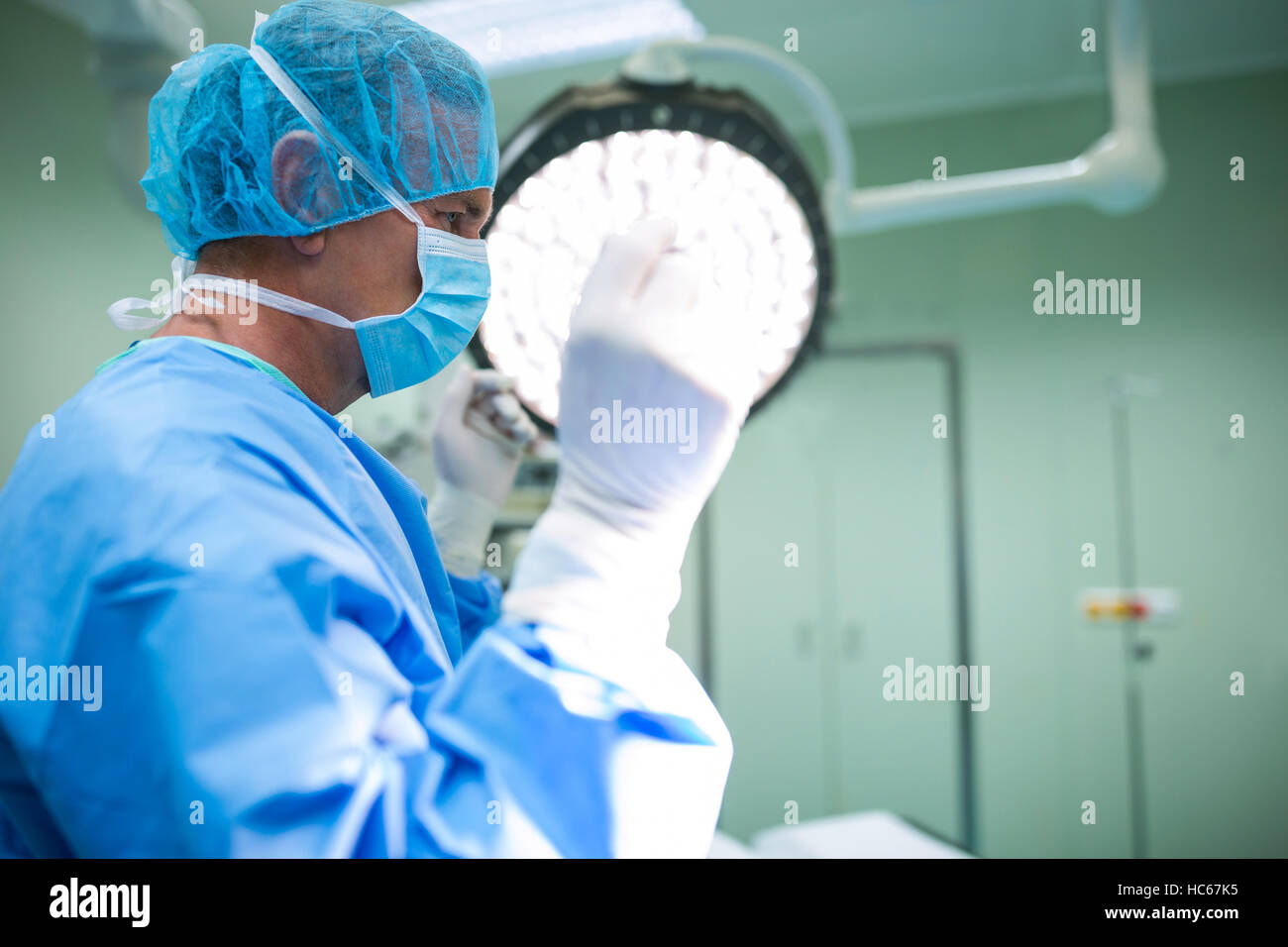 Surgeon standing in operation room Stock Photo - Alamy