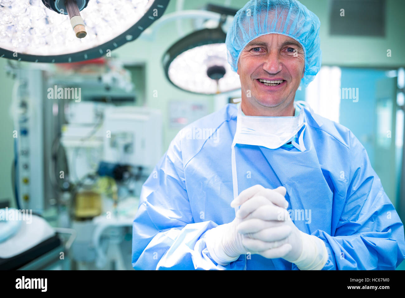 Portrait of smiling surgeons standing in operation room Stock Photo - Alamy