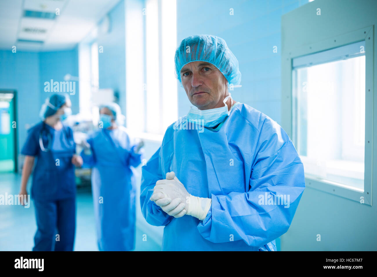 Portrait of surgeon standing in operation room Stock Photo - Alamy