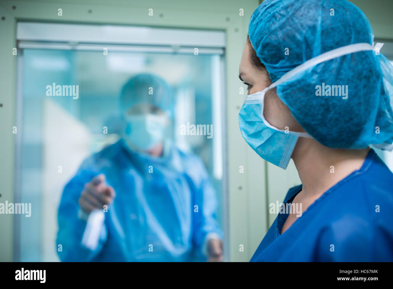 Doctor looking through a glass window Stock Photo - Alamy