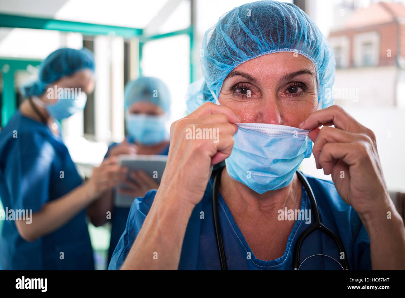 Portrait of surgeon wearing surgical mask in surgical room Stock Photo ...