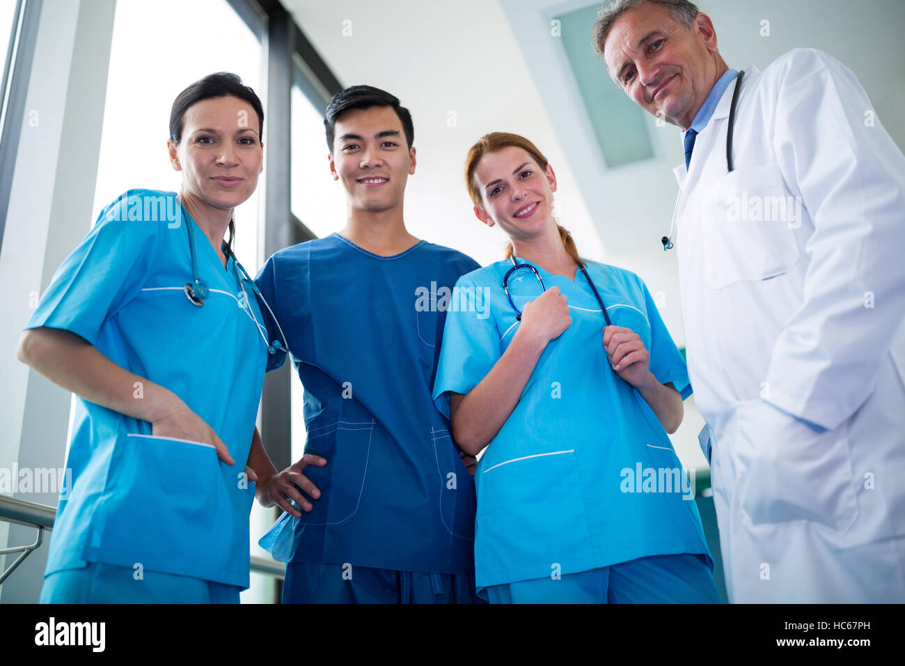 Portrait of doctor and surgeons standing together in corridor Stock ...