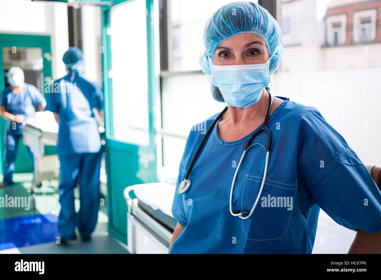 Portrait of surgeon standing in corridor Stock Photo - Alamy