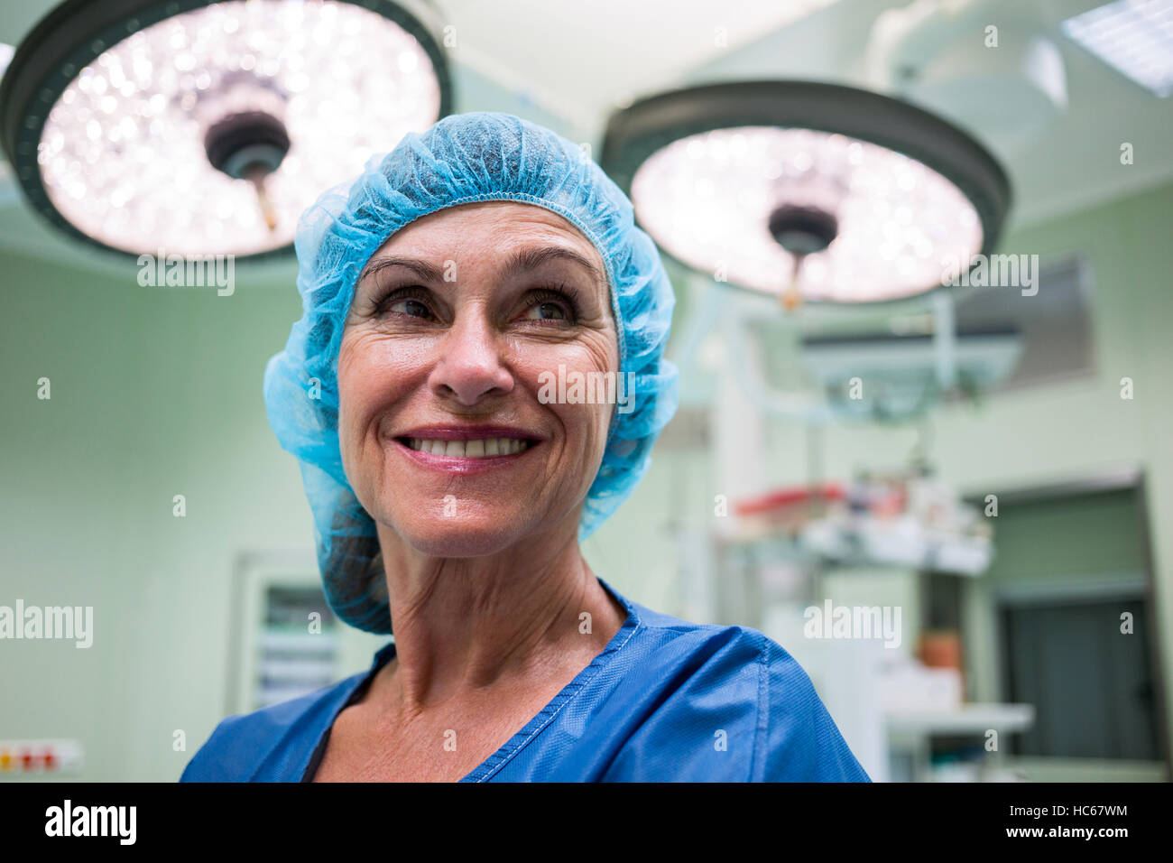 Smiling surgeon standing in operation room Stock Photo - Alamy