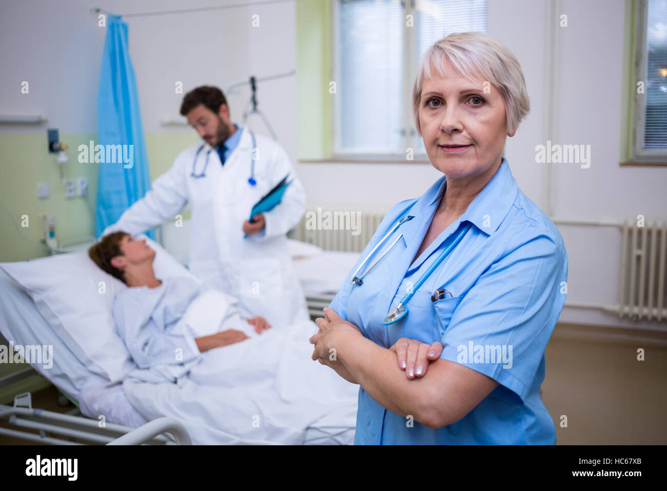Portrait of nurse standing with arms crossed Stock Photo - Alamy