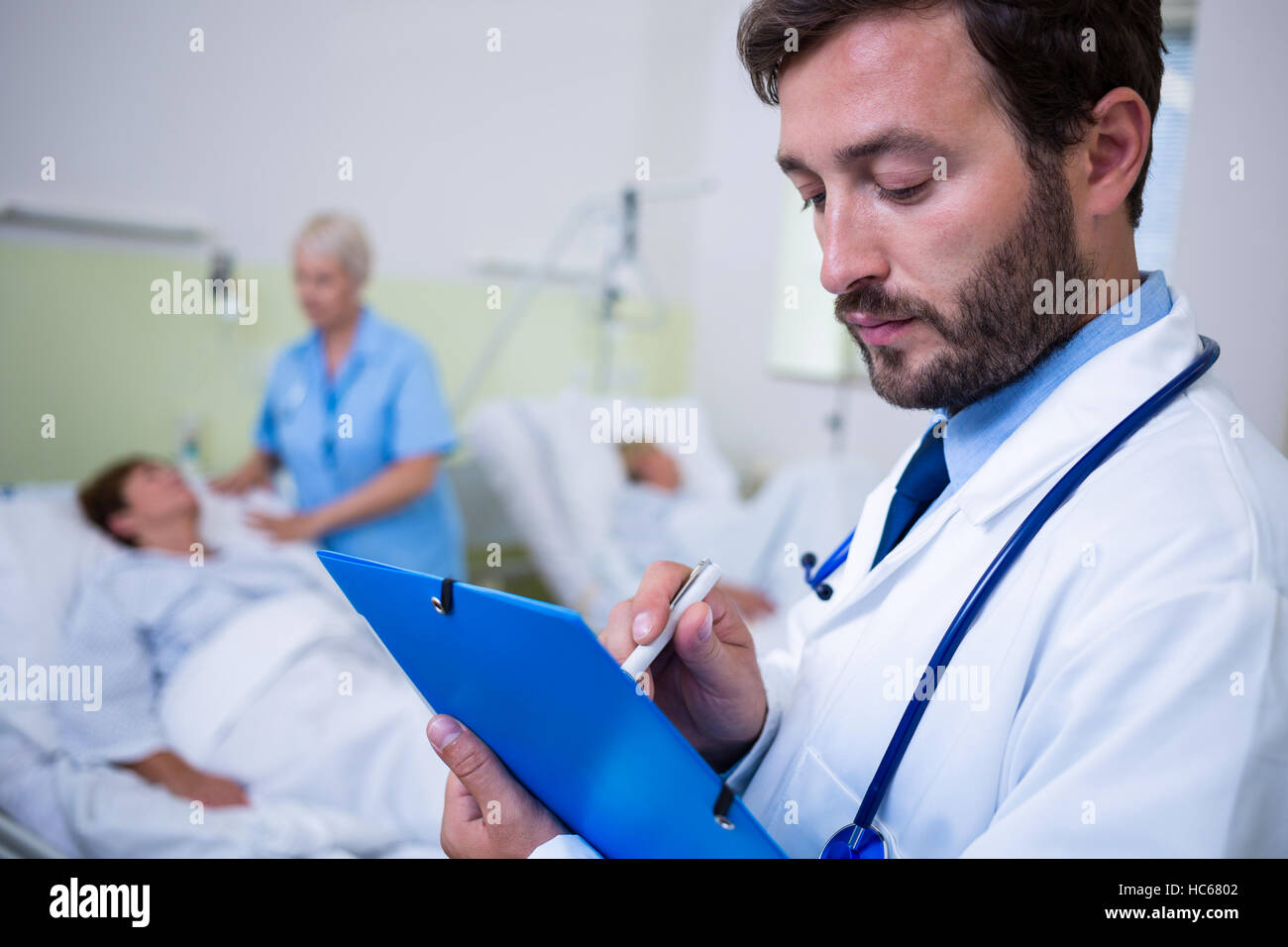Doctor checking a medical report Stock Photo - Alamy