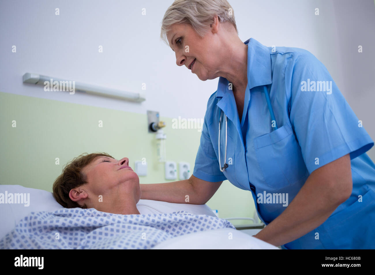 Nurse checking patient temperature Stock Photo - Alamy