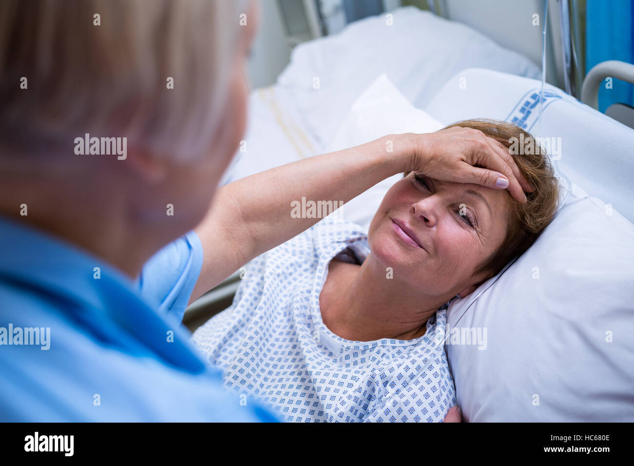 Nurse checking patient temperature Stock Photo - Alamy