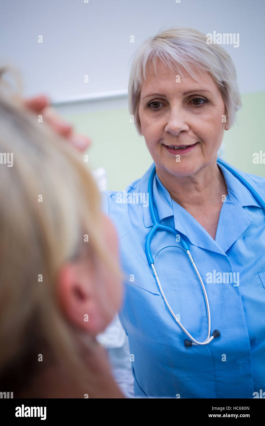 Nurse checking patient temperature Stock Photo - Alamy