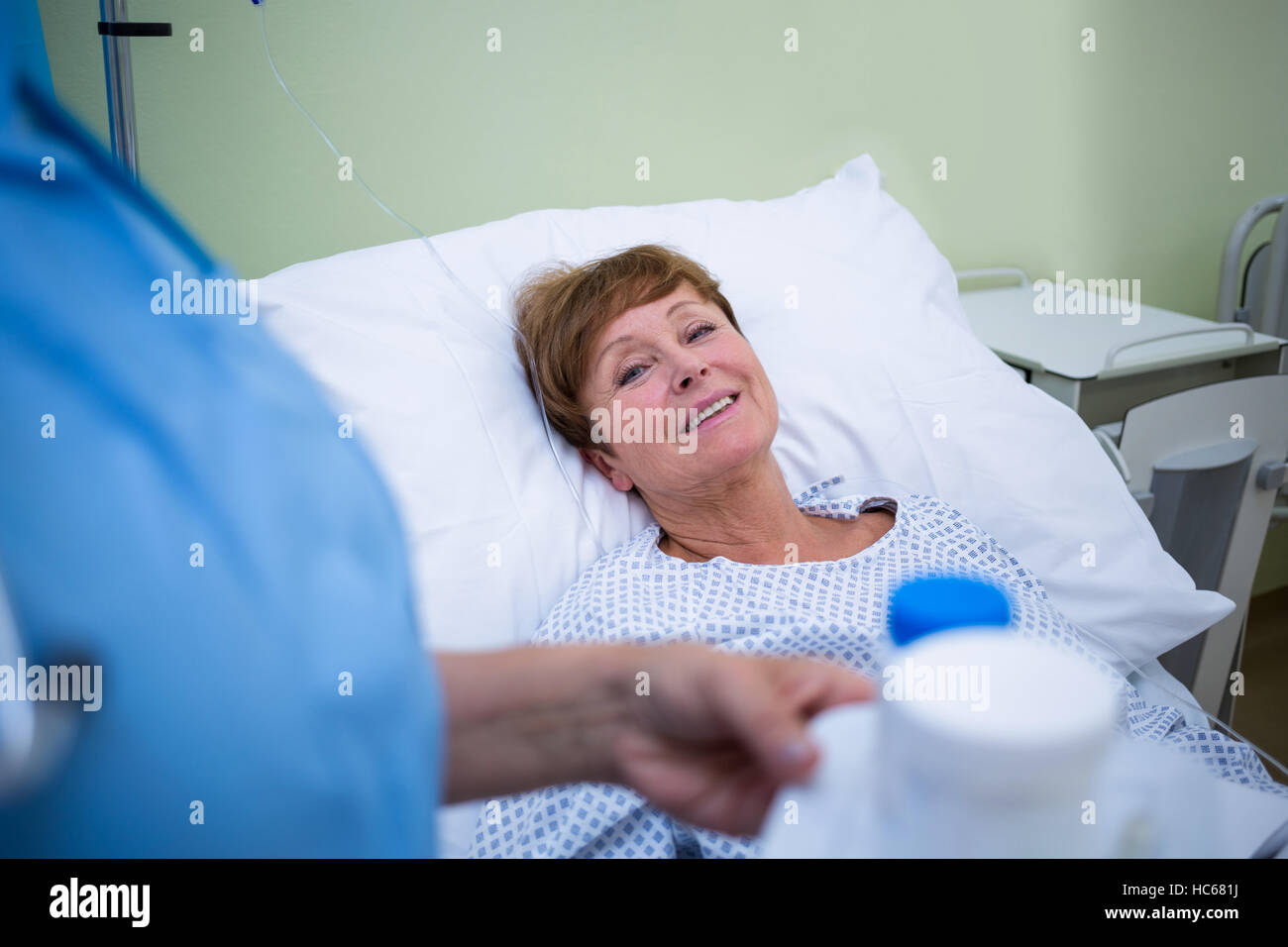 Nurse giving medication to patient Stock Photo - Alamy