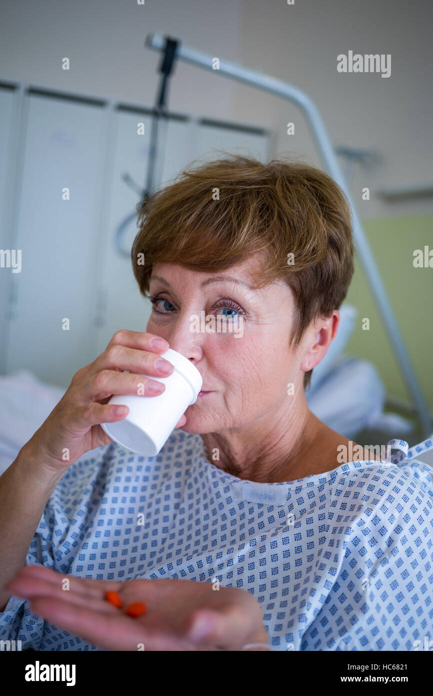 Portrait of patient taking medication Stock Photo - Alamy