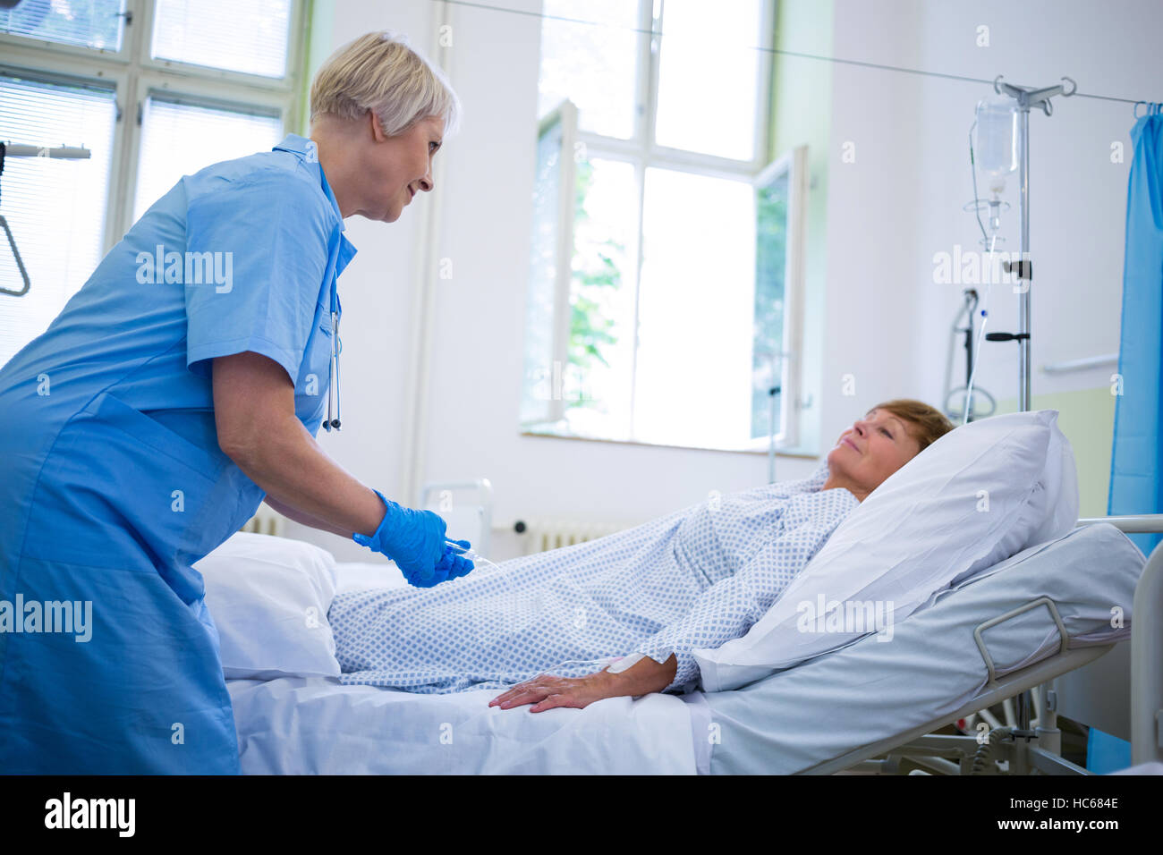Nurse giving an injection to a patient Stock Photo - Alamy