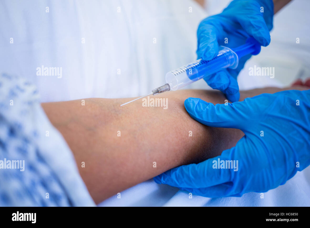 Nurse giving an injection to a patient Stock Photo - Alamy
